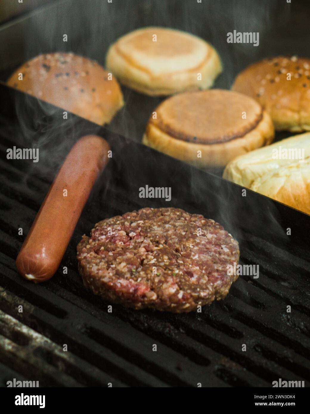 parts of a burger and hotdog being cooked Stock Photo - Alamy