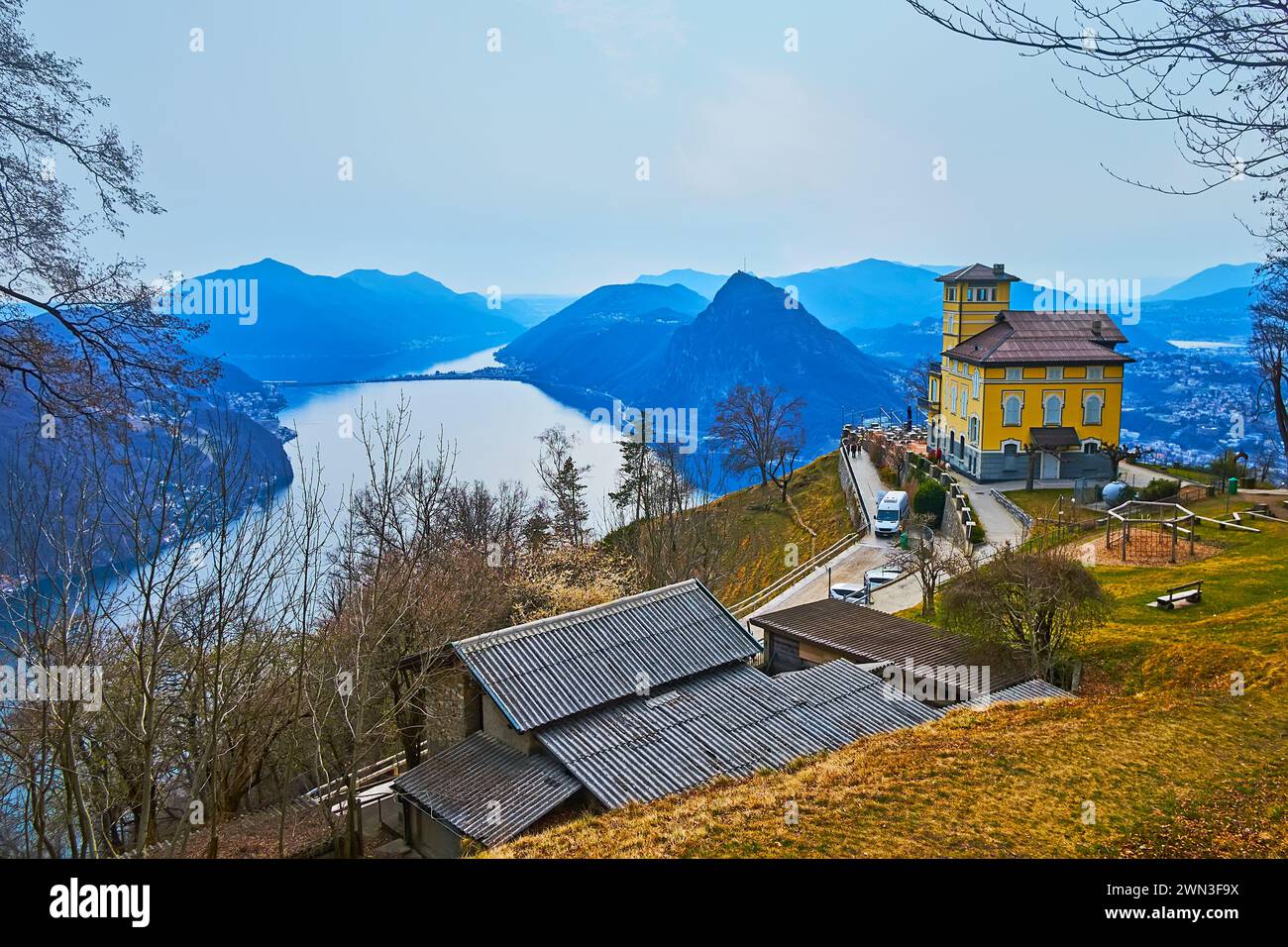 The peak of Monte Bre with a building of restaurant against Monte San ...