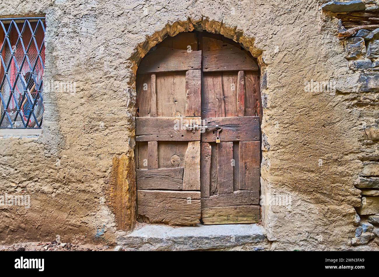 The beautiful medieval arched wooden door with old latch and lock, Bre ...