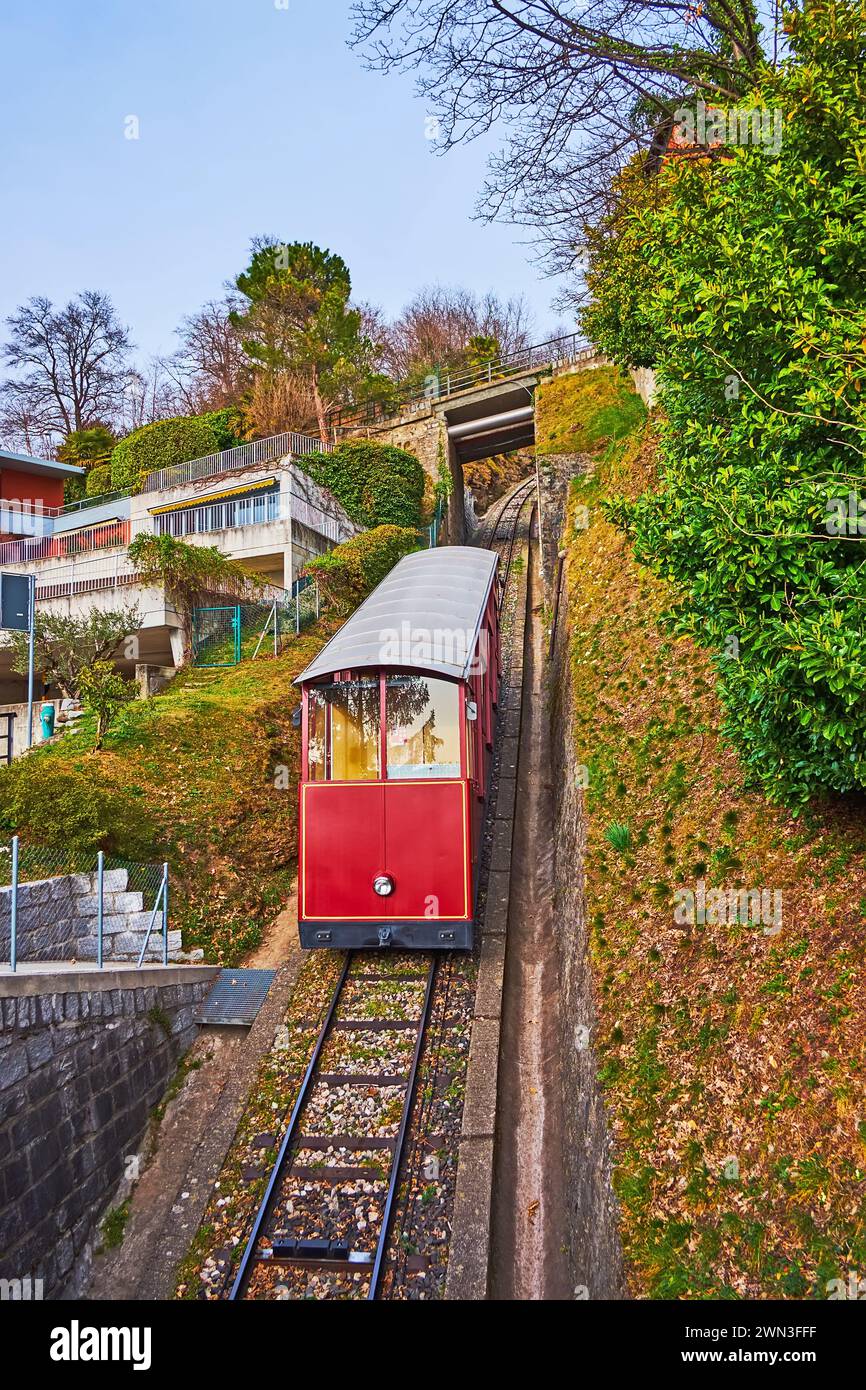 The vintage red Monte Bre Funicular car, riding up the mountain slope ...