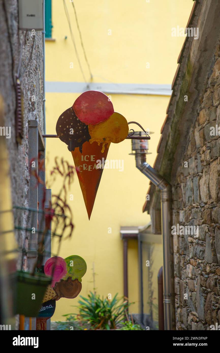 an ice cream sign hanging on a narrow alley, Italy Stock Photo - Alamy