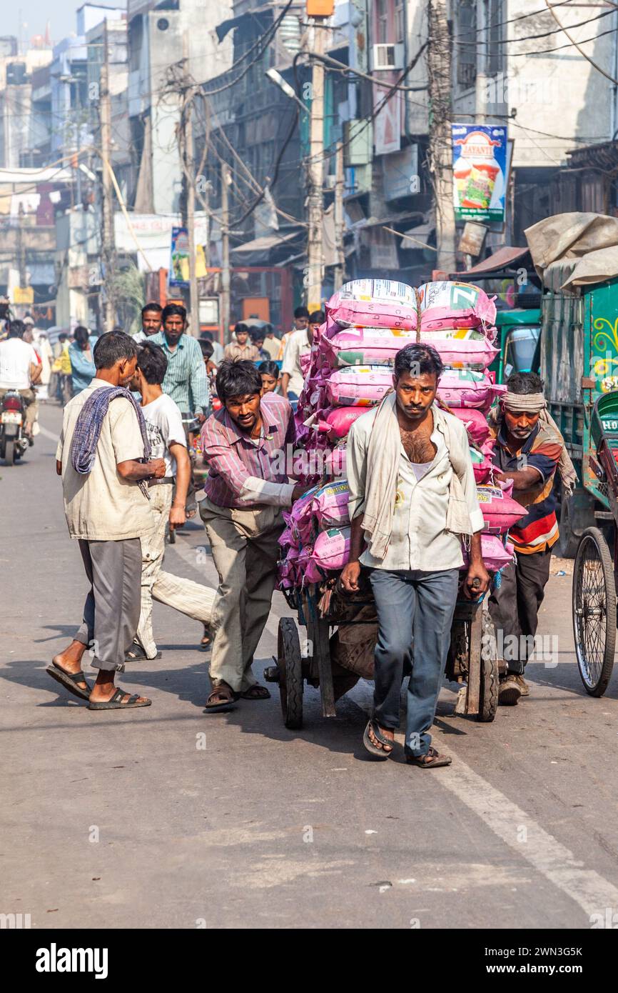 DELHI, INDIA - NOV 9: A pushcart is pulled by people early morning on ...