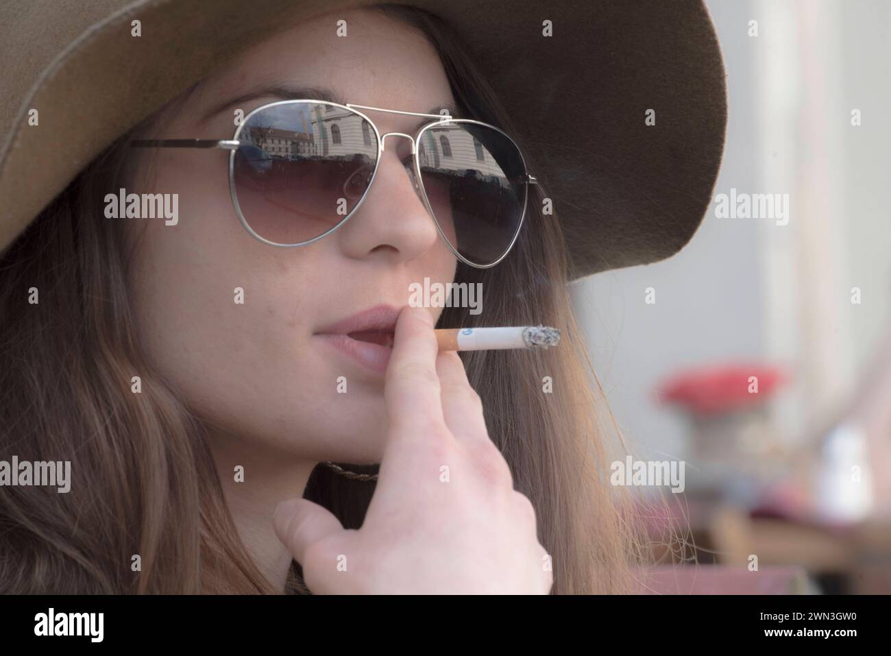a woman smoking a cigarette, female person with nicotine addiction a ...