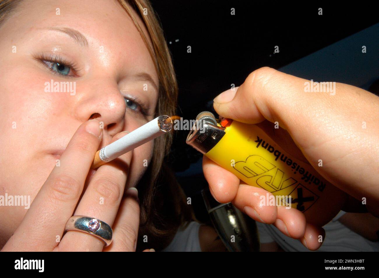 a woman smoking a cigarette, female person with nicotine addiction a ...