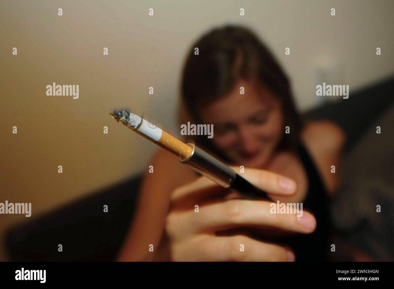 a woman smoking a cigarette, female person with nicotine addiction a ...