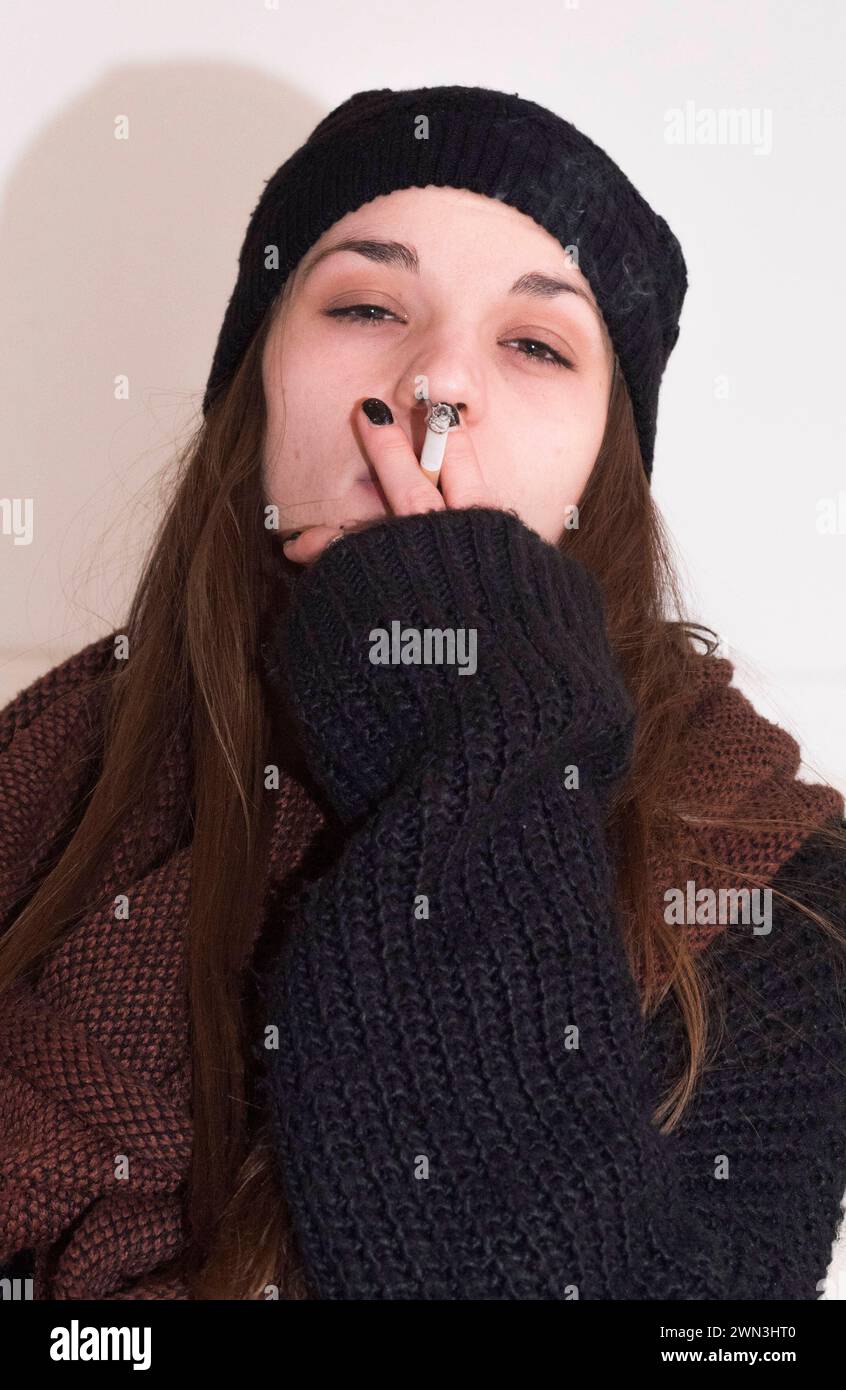a woman smoking a cigarette, female person with nicotine addiction a ...