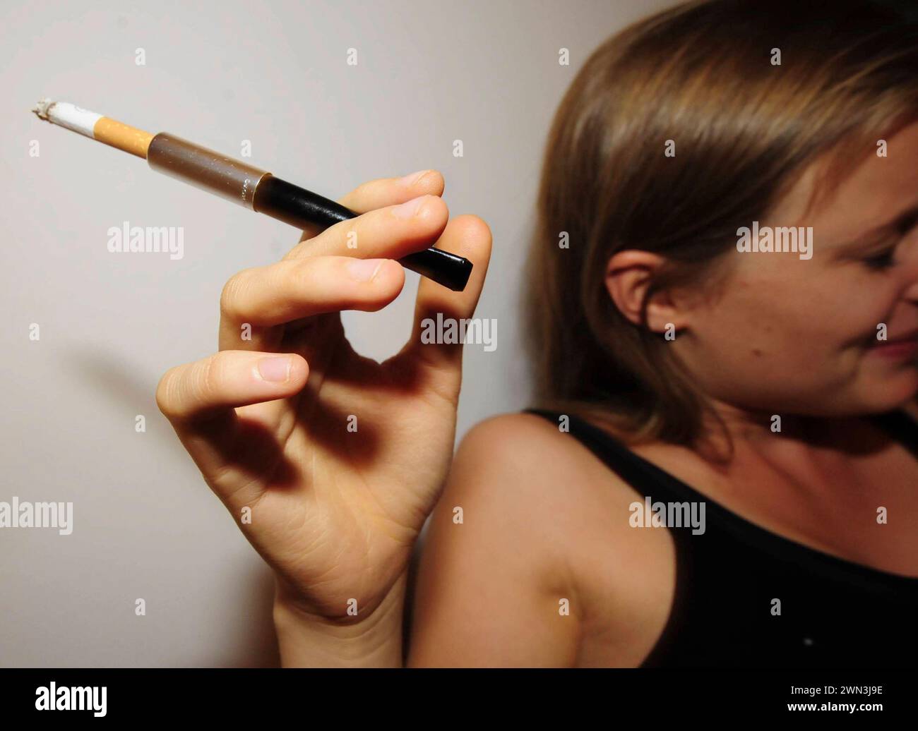 a woman smoking a cigarette, female person with nicotine addiction a ...