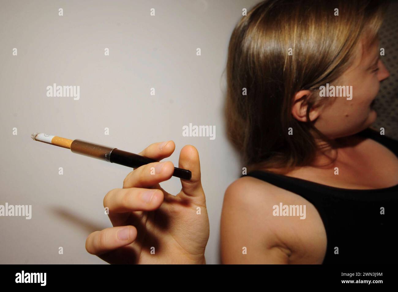 a woman smoking a cigarette, female person with nicotine addiction a ...