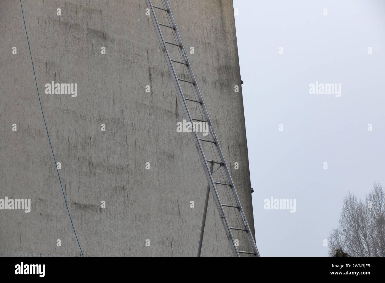 High ladder against the wall of a block of flats Stock Photo - Alamy