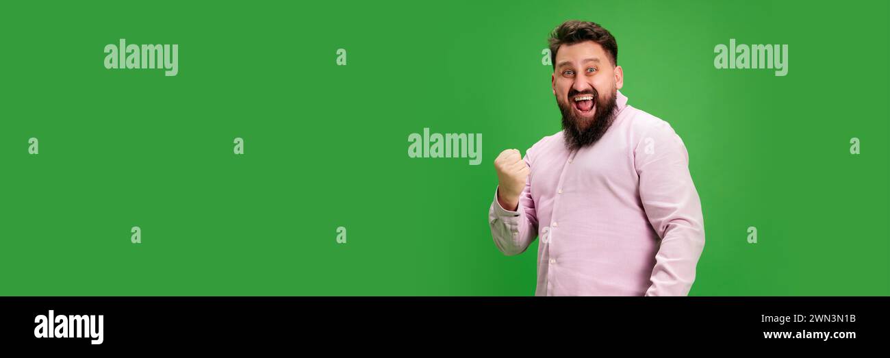 Banner. Young smiling man rejoice success and clenched fist against ...