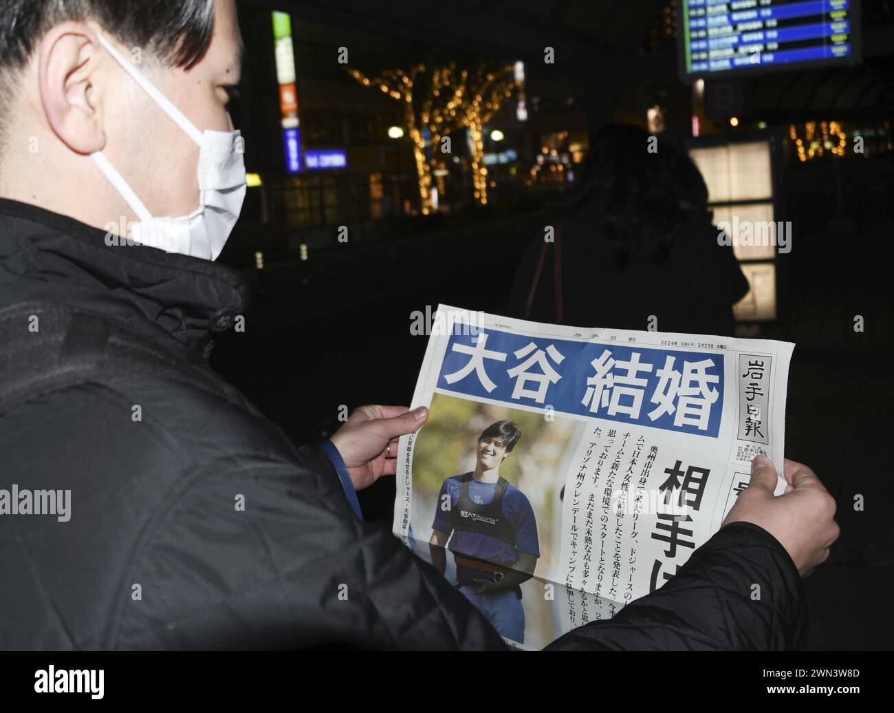 A man reads a copy of an extra edition of the Iwate Nippon daily ...