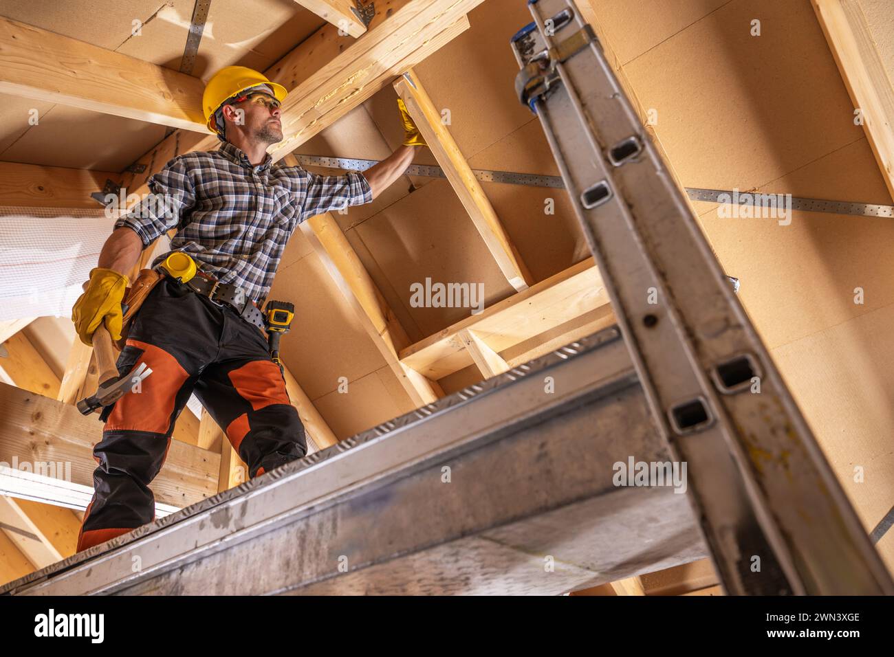 Construction Contractor Worker on a Scaffolding Performing Roof ...