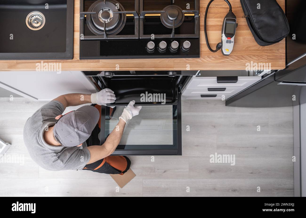 Professional Appliances Installer and Testing New Kitchen Stove. Top ...