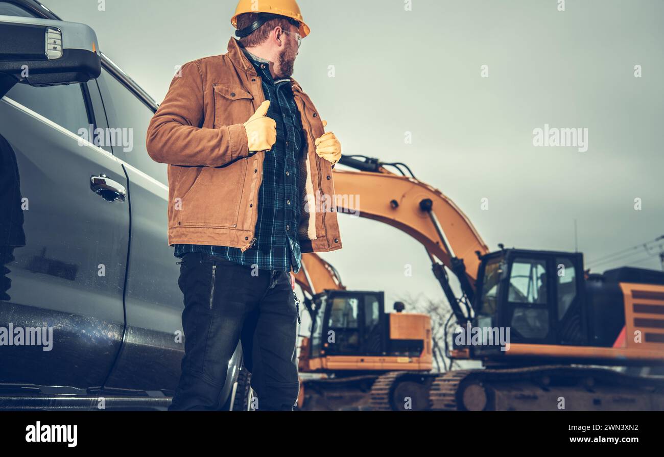 Caucasian Construction Site Supervisor Checking on Heavy Ground ...