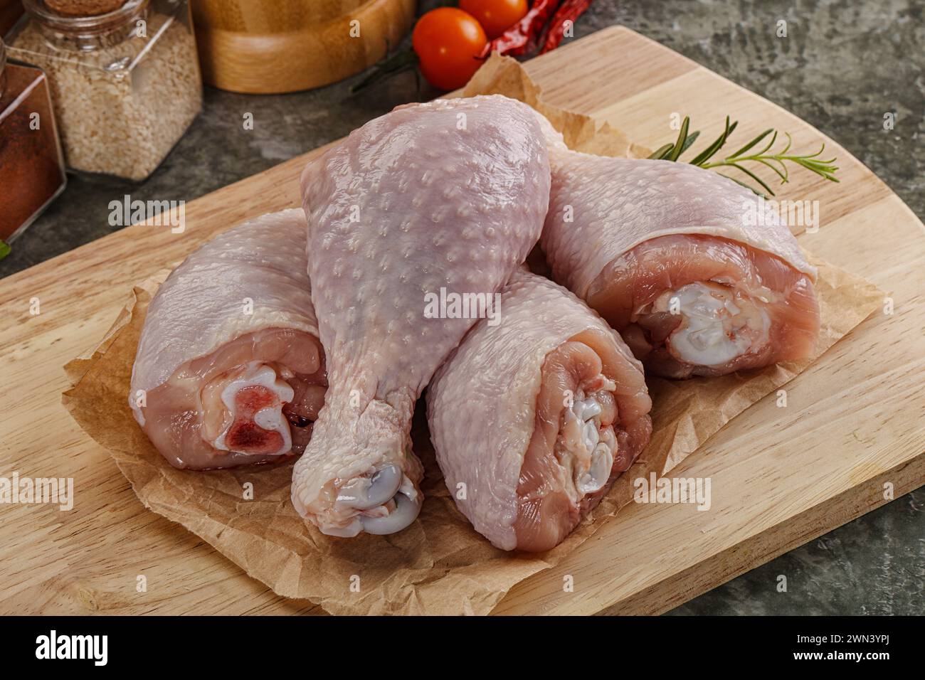 Raw uncooked chicken drumsticks over board for cooking Stock Photo - Alamy