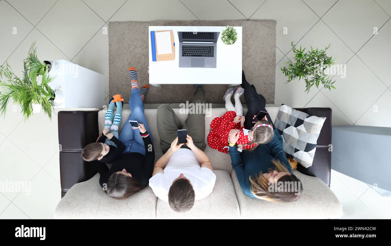 Family using electronic gadgets hi-res stock photography and images - Alamy