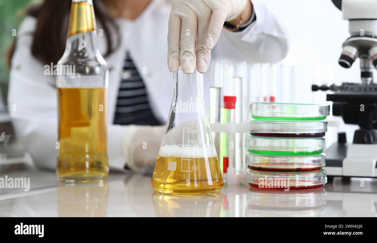 Researcher mixing test tube in lab Stock Photo - Alamy