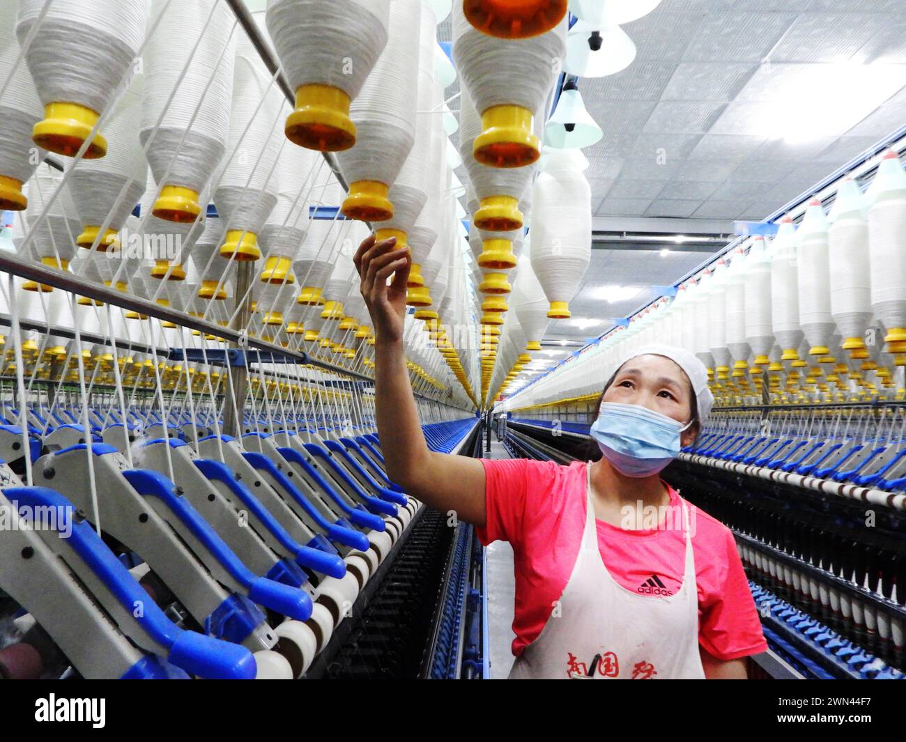 DAZHOU, CHINA - FEBRUARY 29, 2024 - A worker produces cotton products for export to Europe and ...