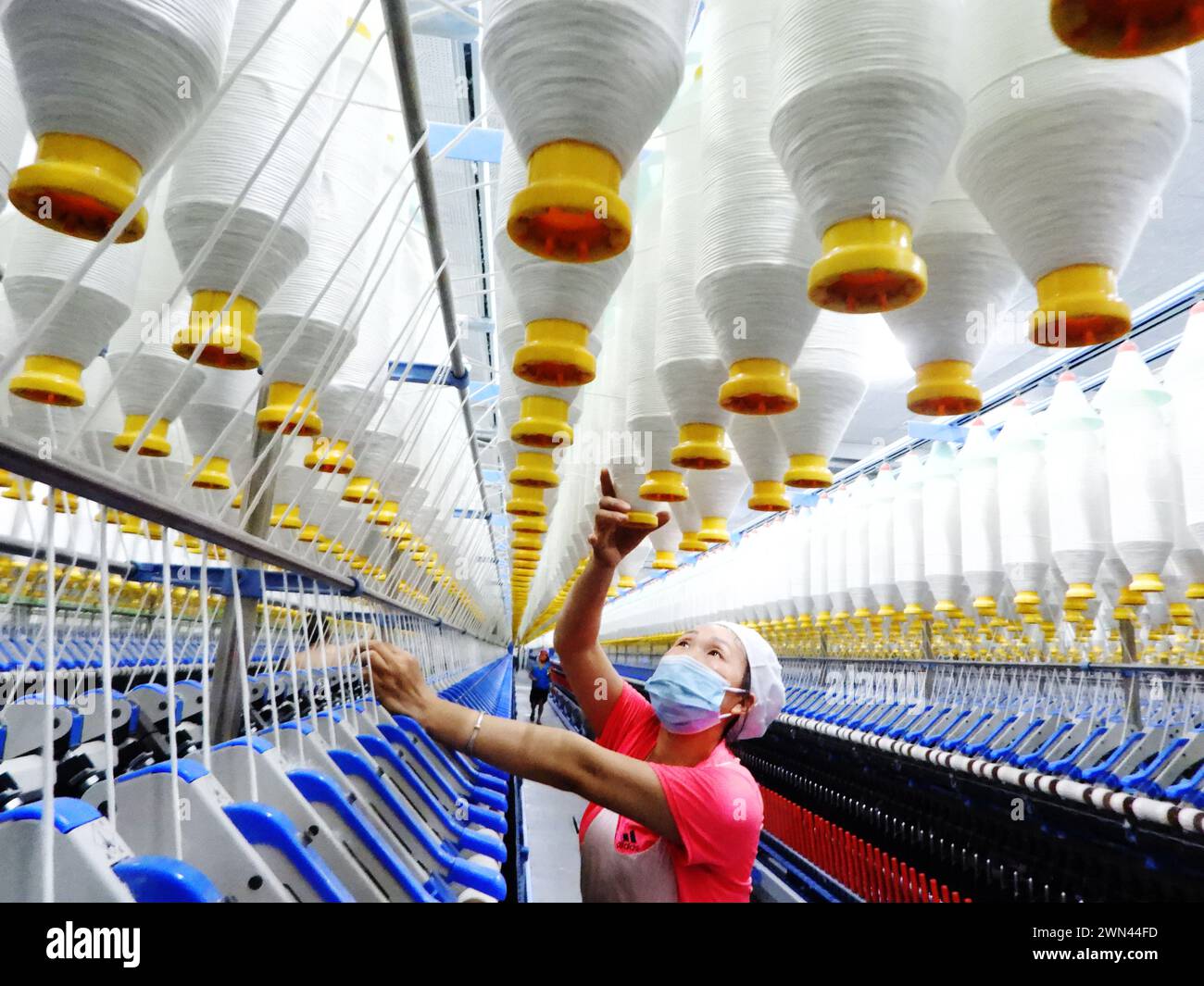DAZHOU, CHINA - FEBRUARY 29, 2024 - A worker produces cotton products for export to Europe and ...