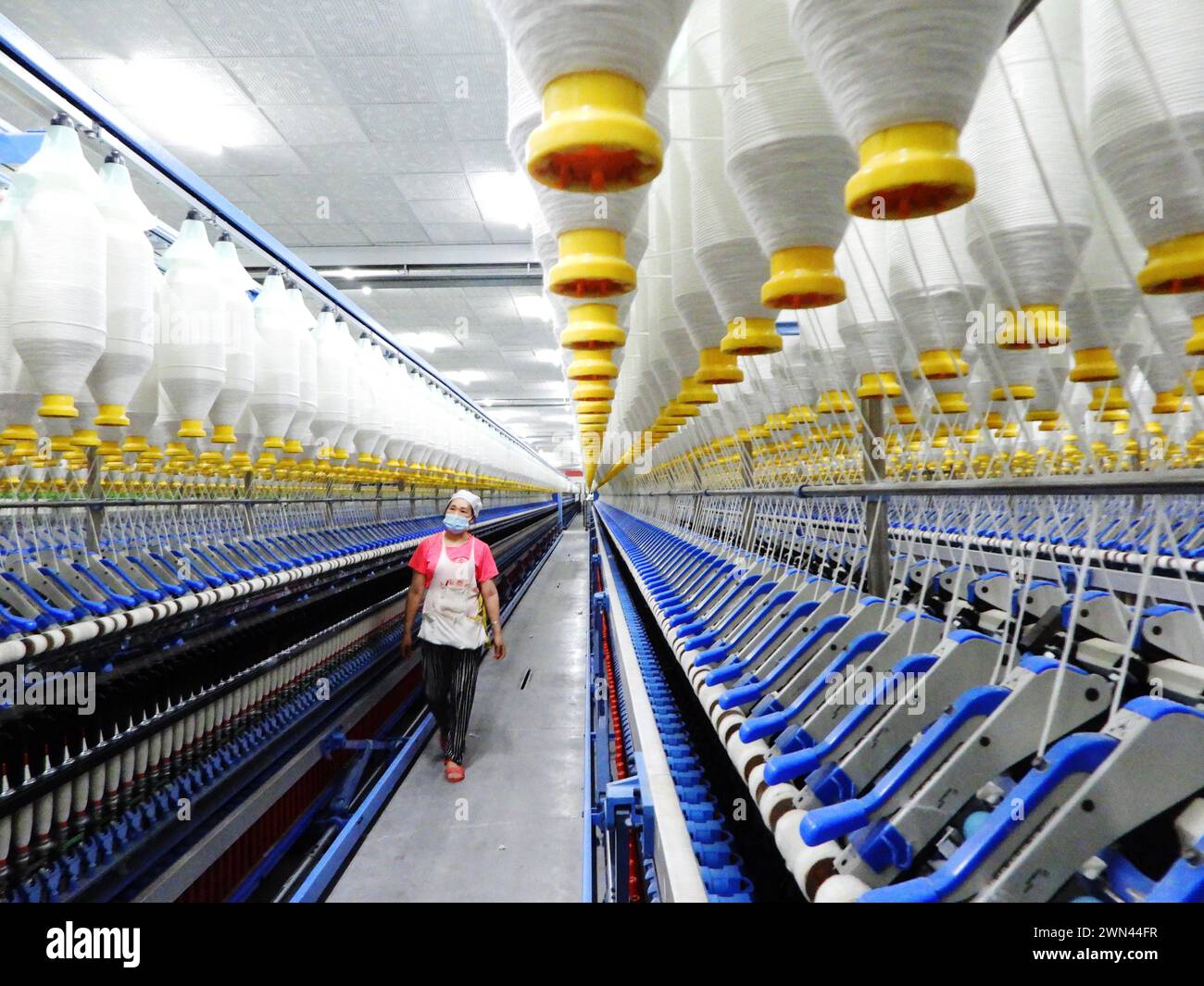 DAZHOU, CHINA - FEBRUARY 29, 2024 - A worker produces cotton products for export to Europe and ...