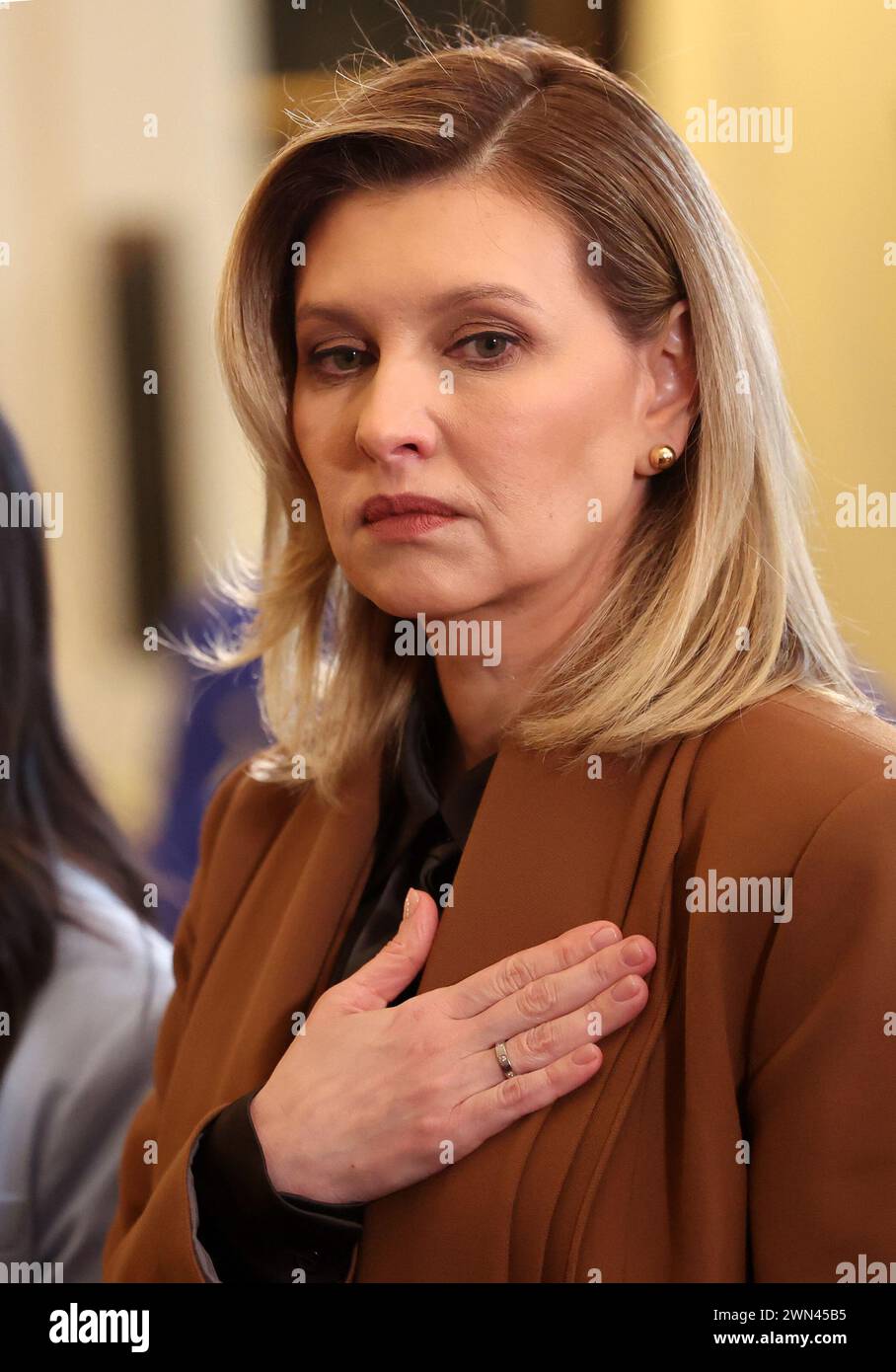 First Lady of Ukraine, Olena Zelenska, listens as singers from the ...
