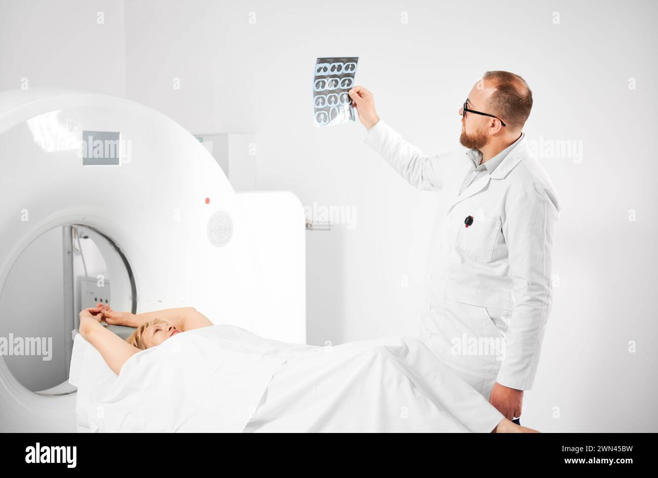 Medical computed tomography or MRI scanner. Doctor holding and ...