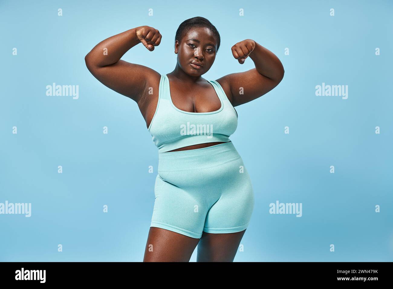 Young african american woman flexing hi-res stock photography and ...
