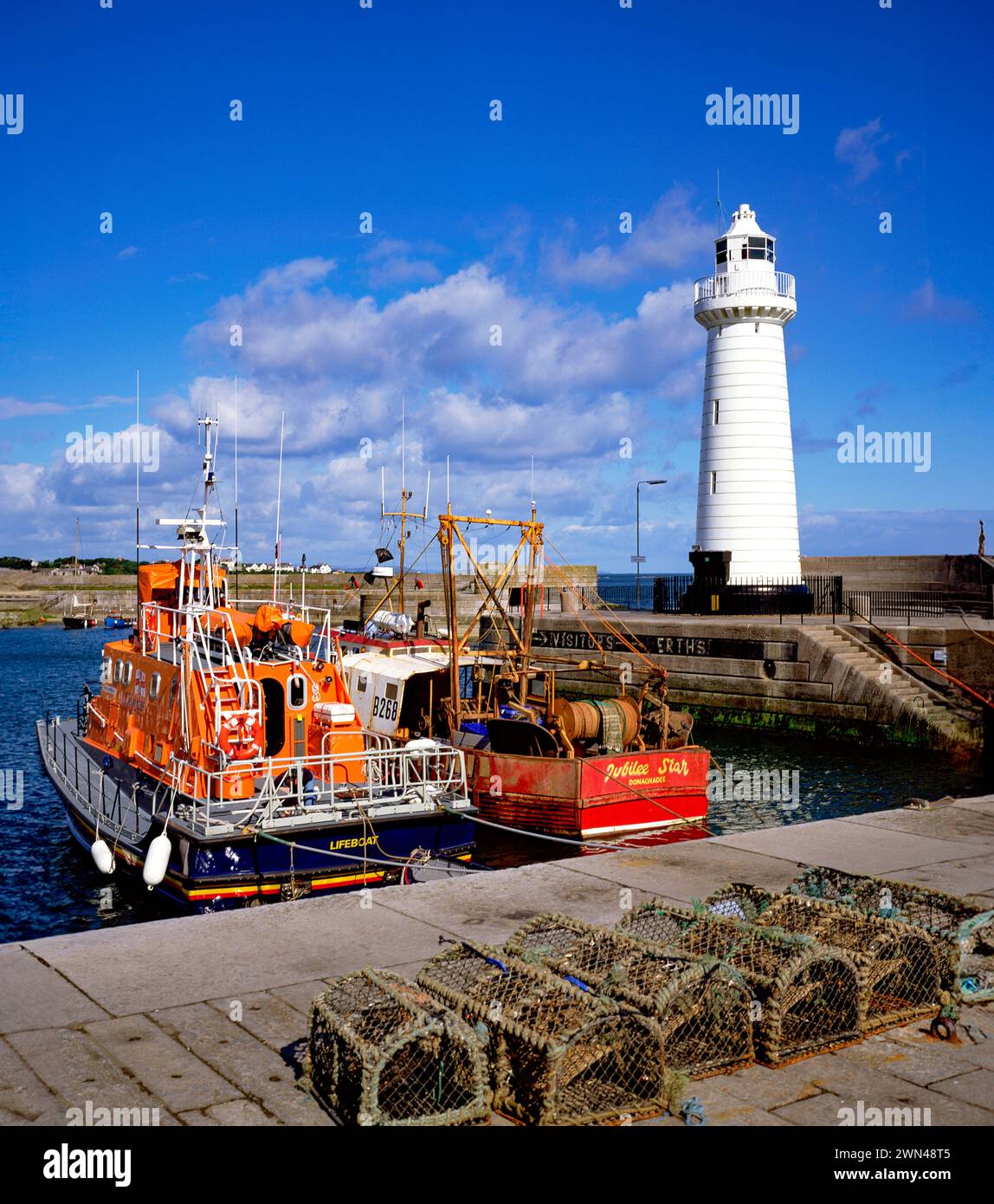Donaghadee Lighthouse and Harbour with fishing and pleasure boats ...