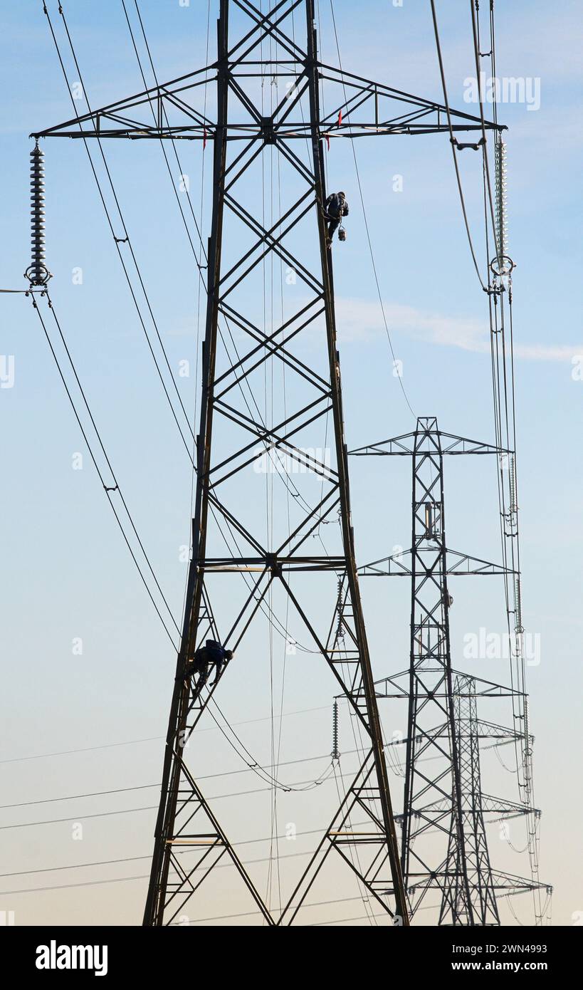 29/11/12 Workmen paint high voltage electricity pylons near Alderley ...
