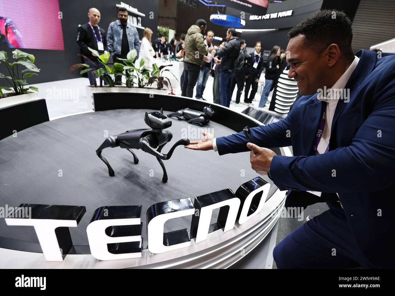 Barcelona, Spain. 26th Feb, 2024. People visit the TECNO booth during ...