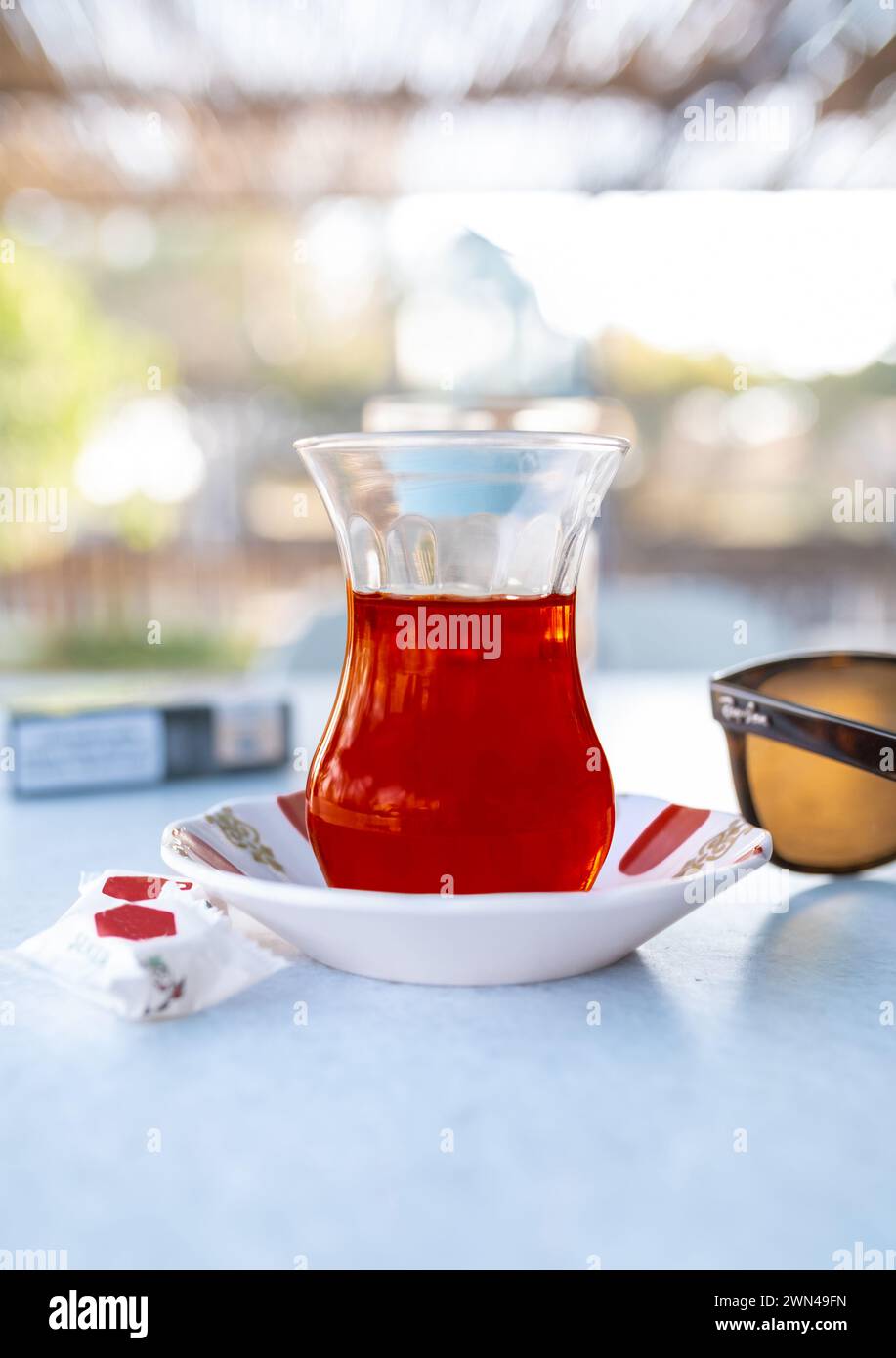 A glass of black tea standing on a table. Drinking tea and coffee ...
