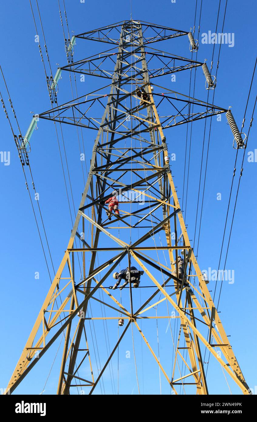 29/11/12 Workmen paint high voltage electricity pylons near Alderley ...