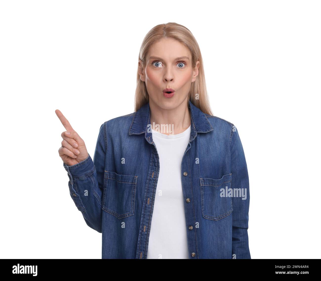 Surprised woman pointing at something on white background Stock Photo ...
