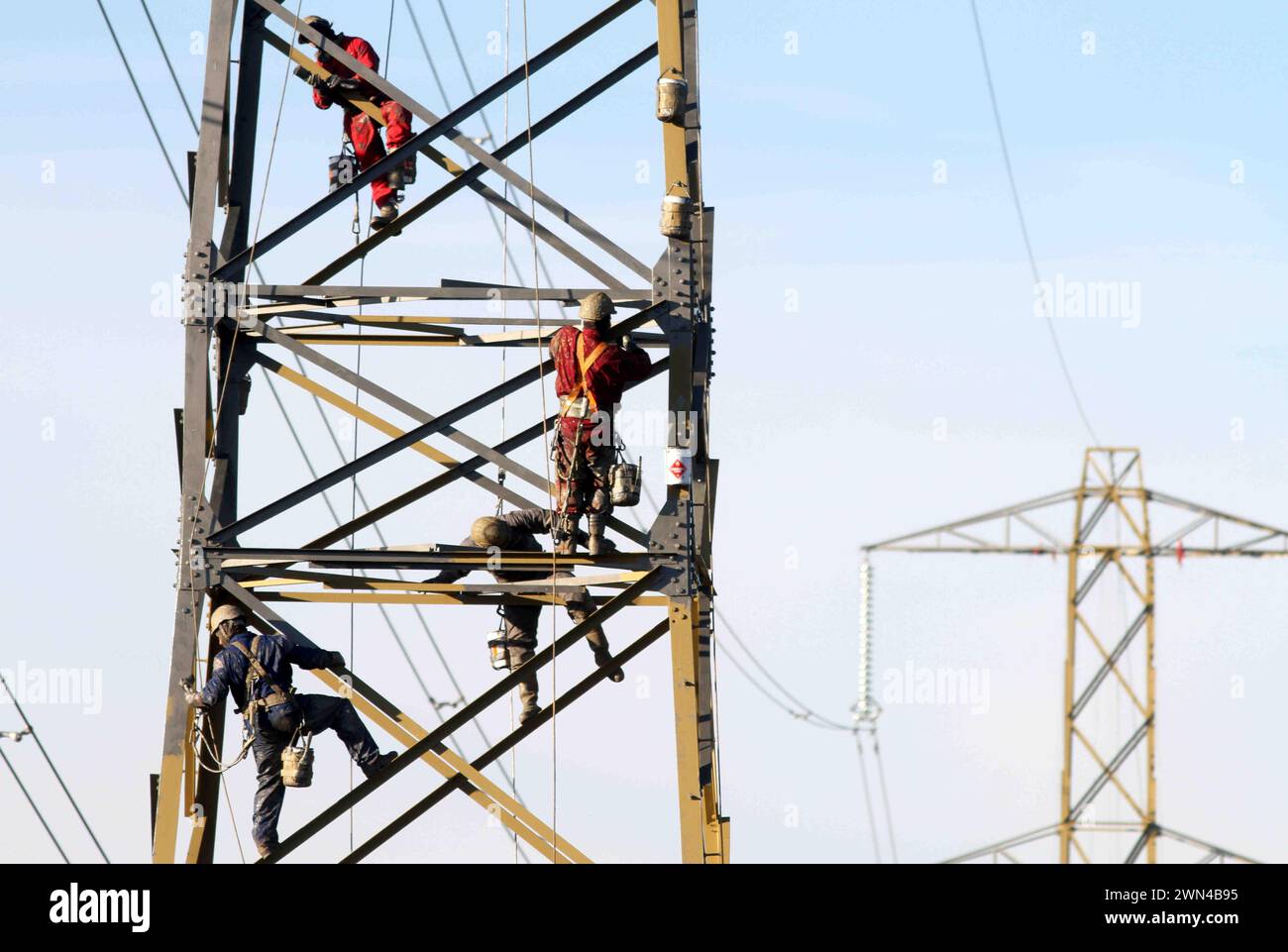 29/11/12 Workmen paint high voltage electricity pylons near Alderley ...
