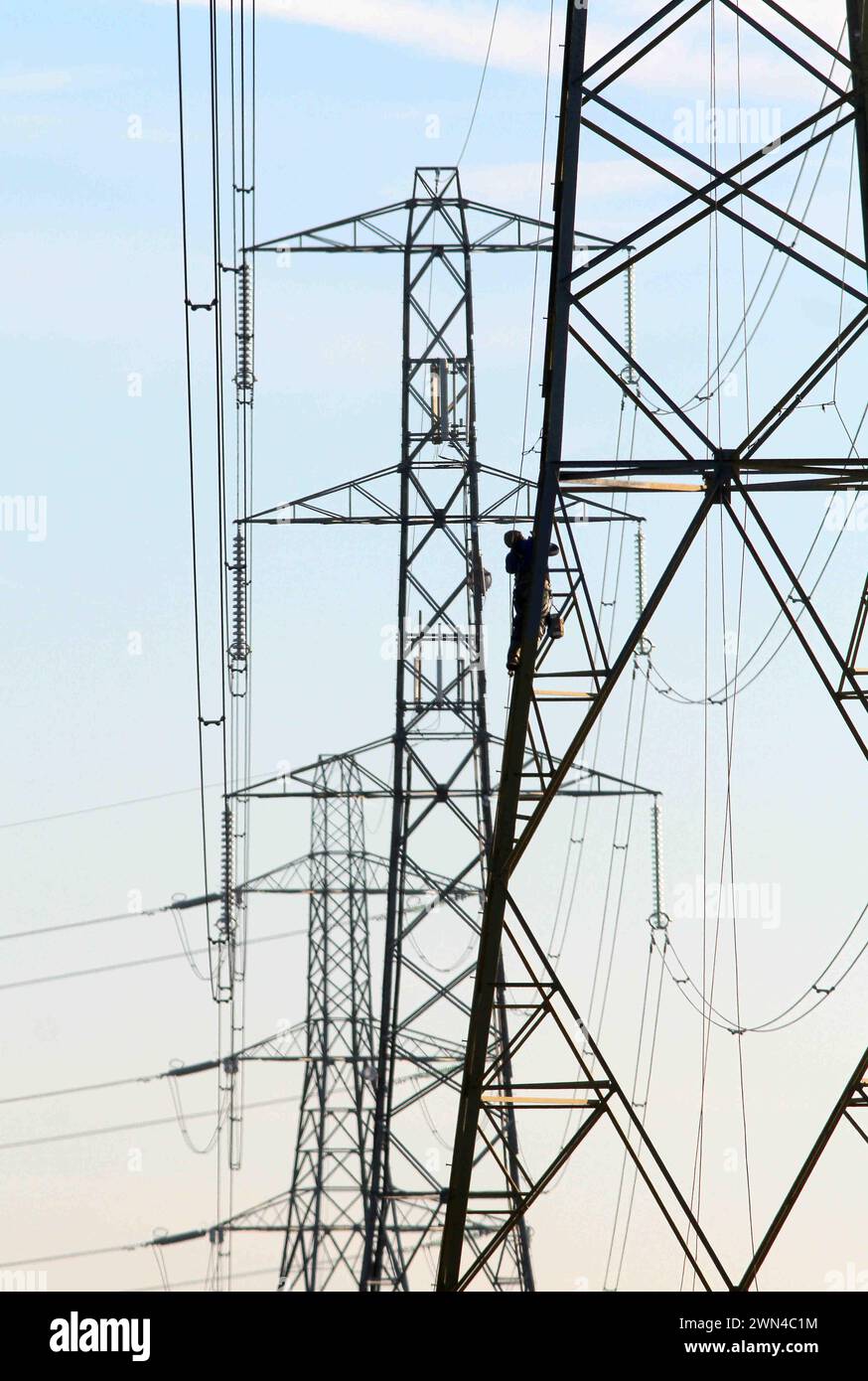29/11/12 Workmen paint high voltage electricity pylons near Alderley ...