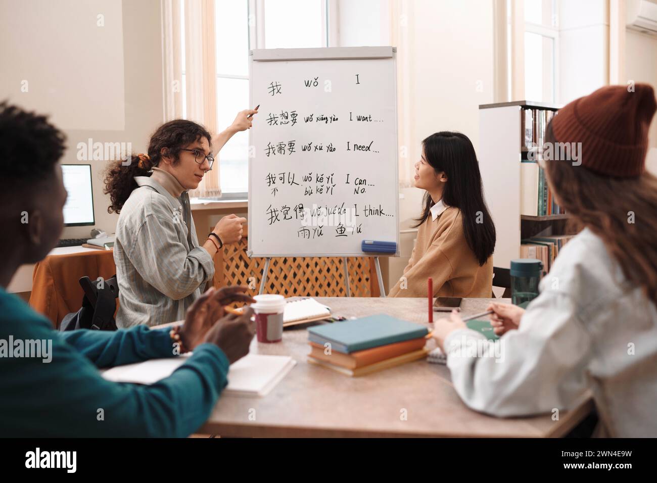 Side view portrait of male student answering questions during Chinese ...