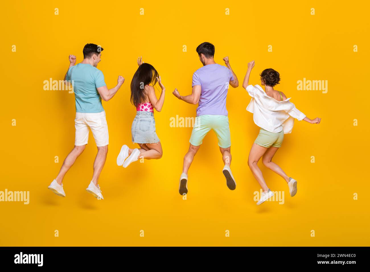 Full length photo of best buddies jump rear view raise hands up ...