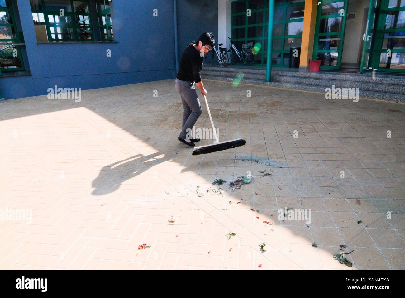 floor cleaning with a broom, sweeping away the dirt and dust floor ...
