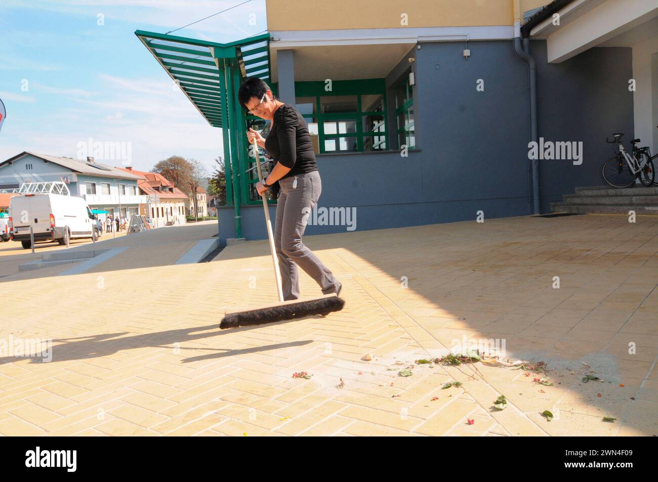 floor cleaning with a broom, sweeping away the dirt and dust floor ...