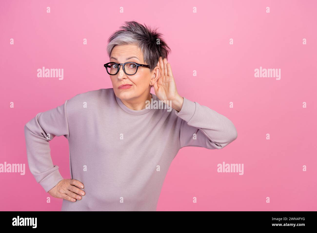 Photo of funny expression mature age woman touch ear listening ...