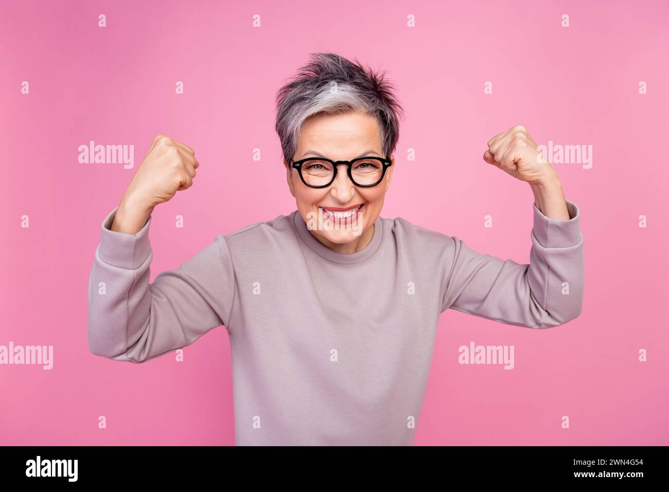 Photo of cheerful crazy funny retired woman grandmother showing biceps ...