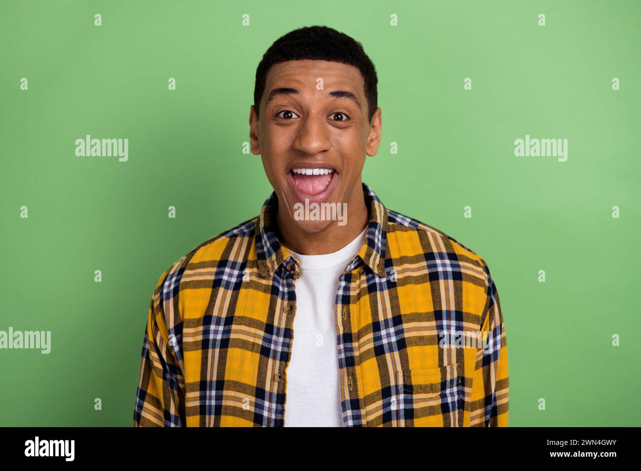 Portrait of funny positive student man in yellow shirt laughing amazed ...