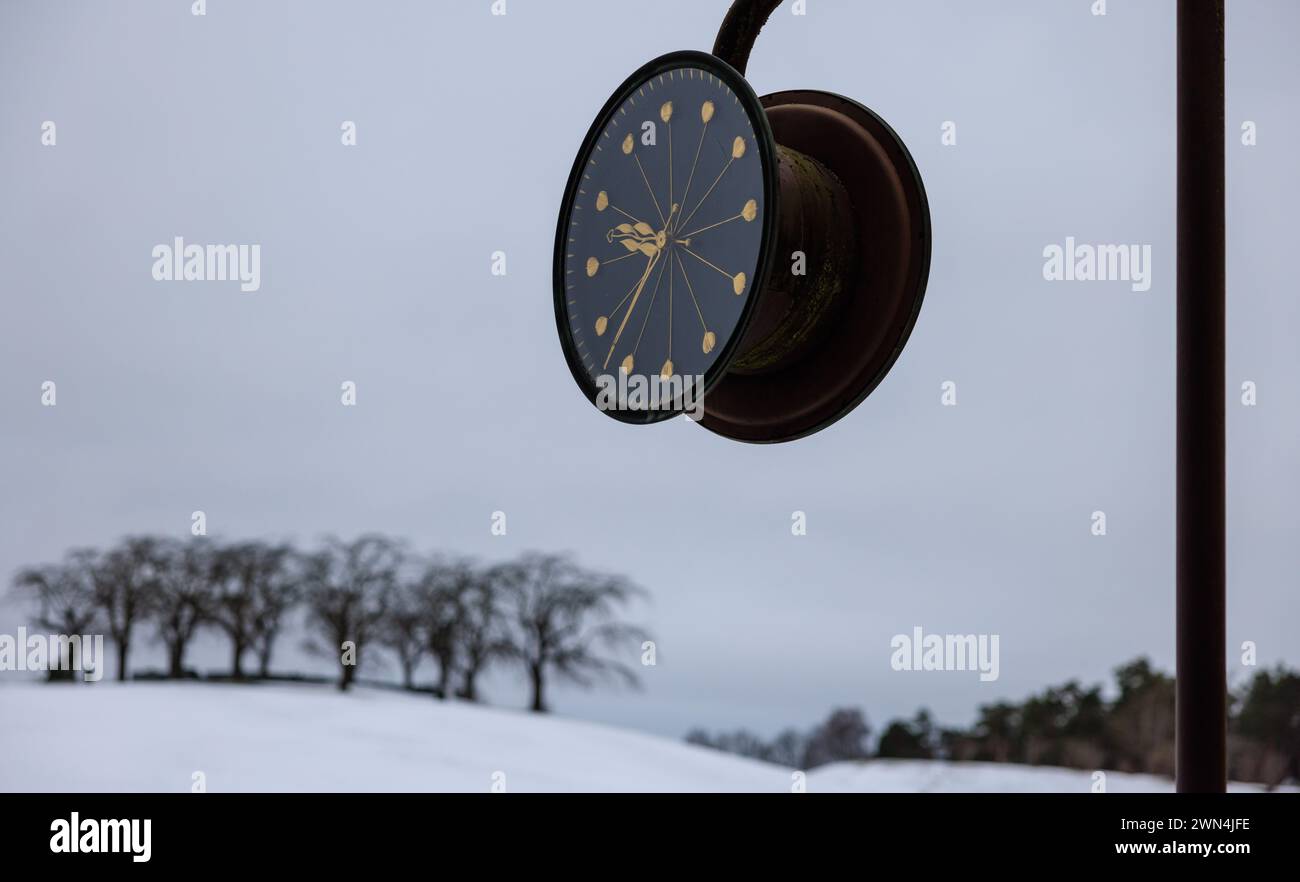 stockholm woodland cemetery a large black clock with gol hands hangs ...