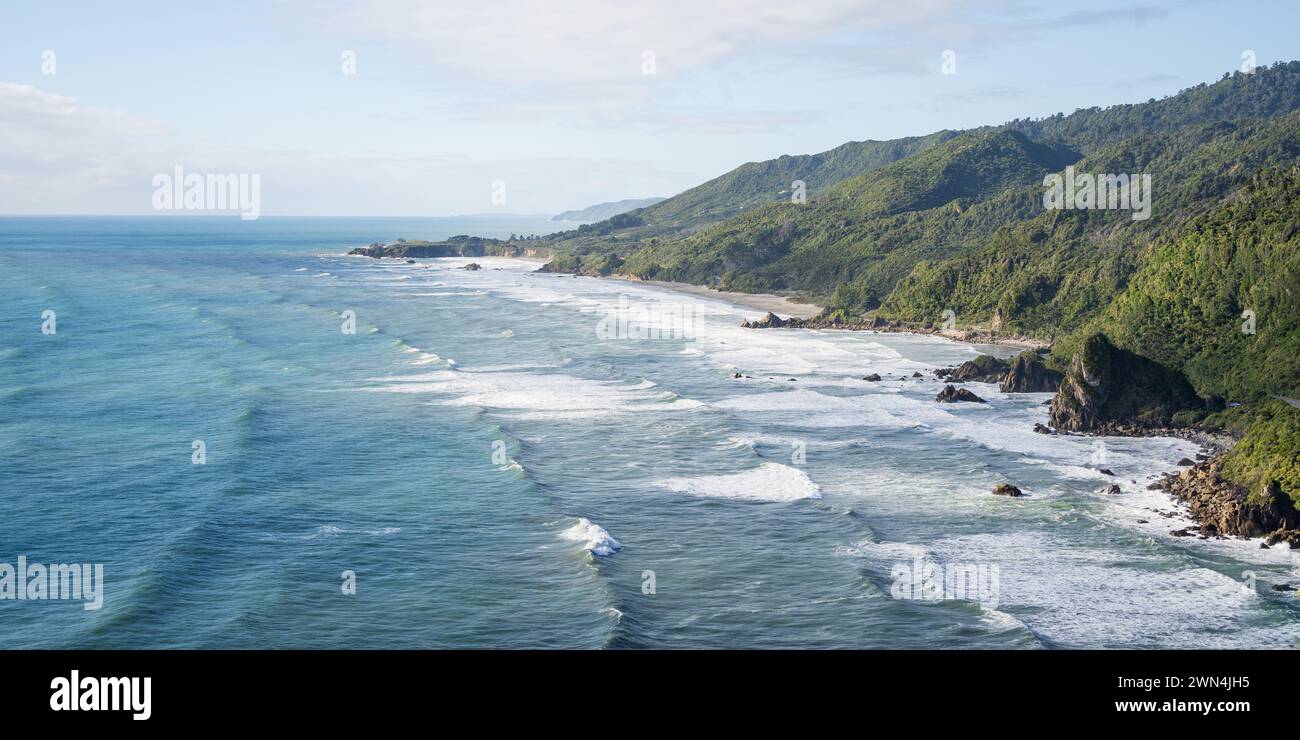 Rough exotic coast with azure ocean water, big waves and rainforest ...