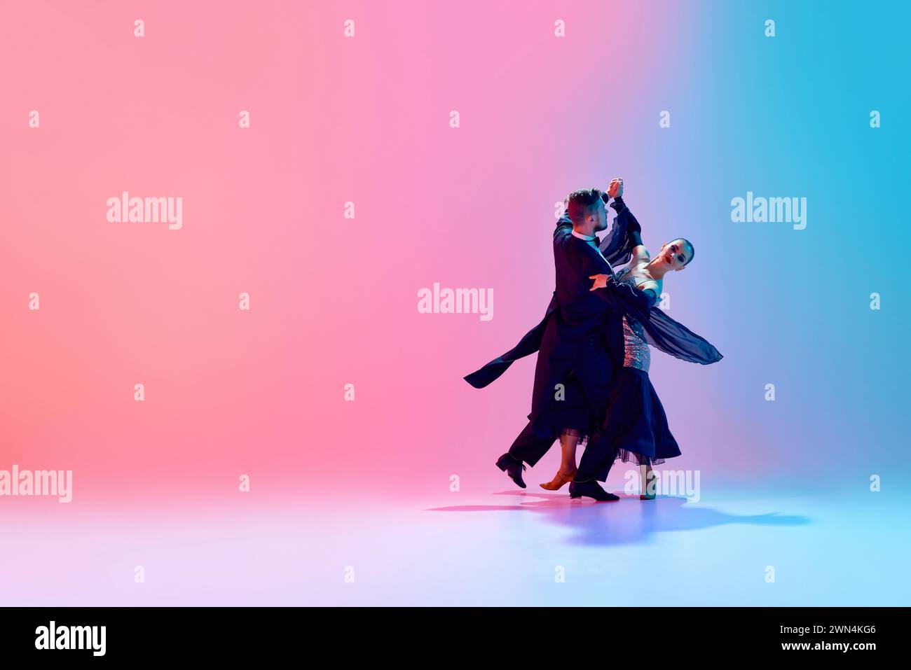 Young man and woman, talented ballroom dancers in motion, dancing in ...