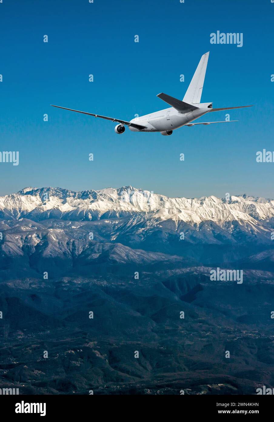 A white wide body airplane approach in a resort mountain town Stock ...