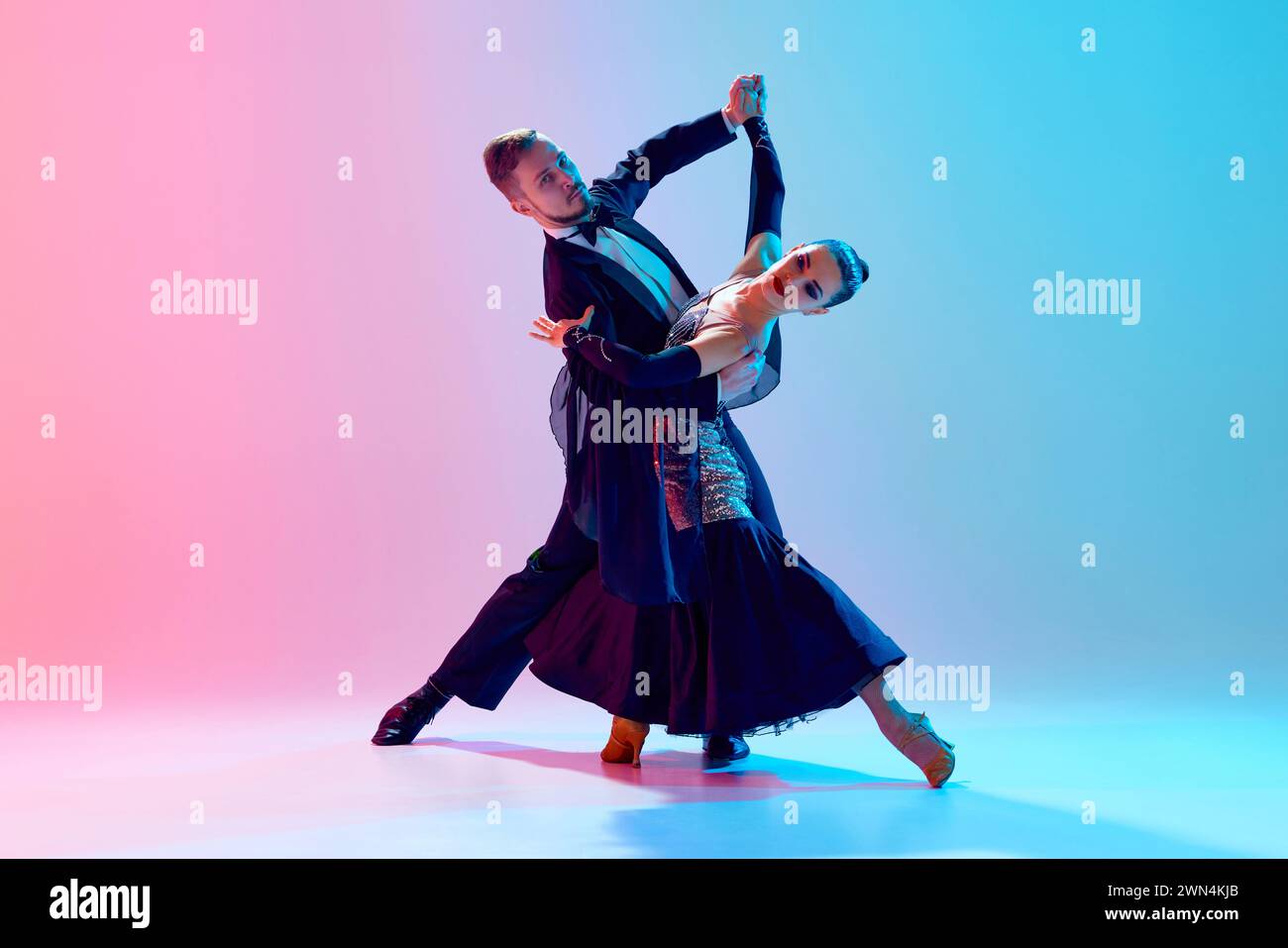 Elegant, passionate young couple, man and woman dancing ballroom in ...