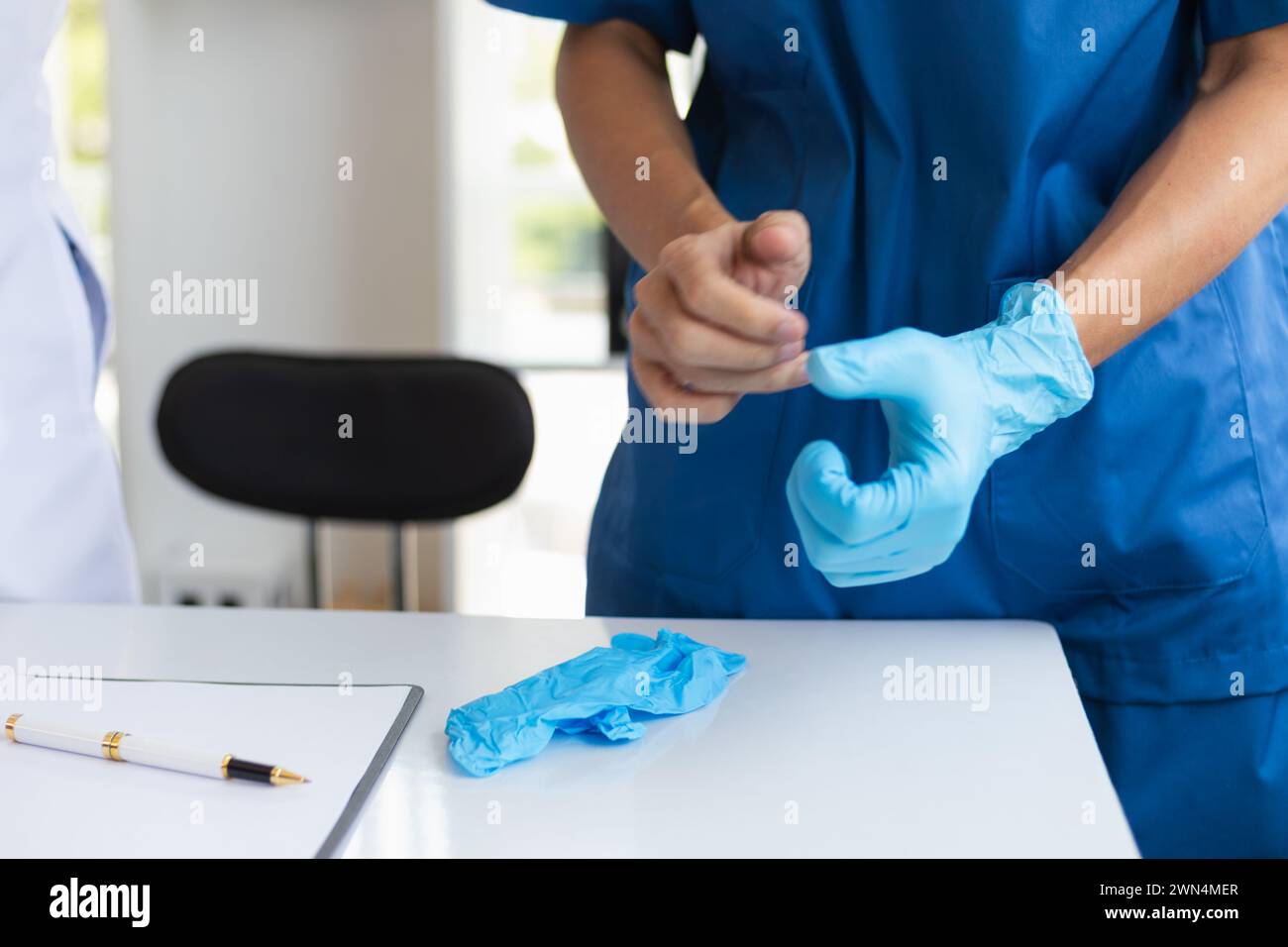 doctor is wearing blue rubber gloves prevent direct contact with ...