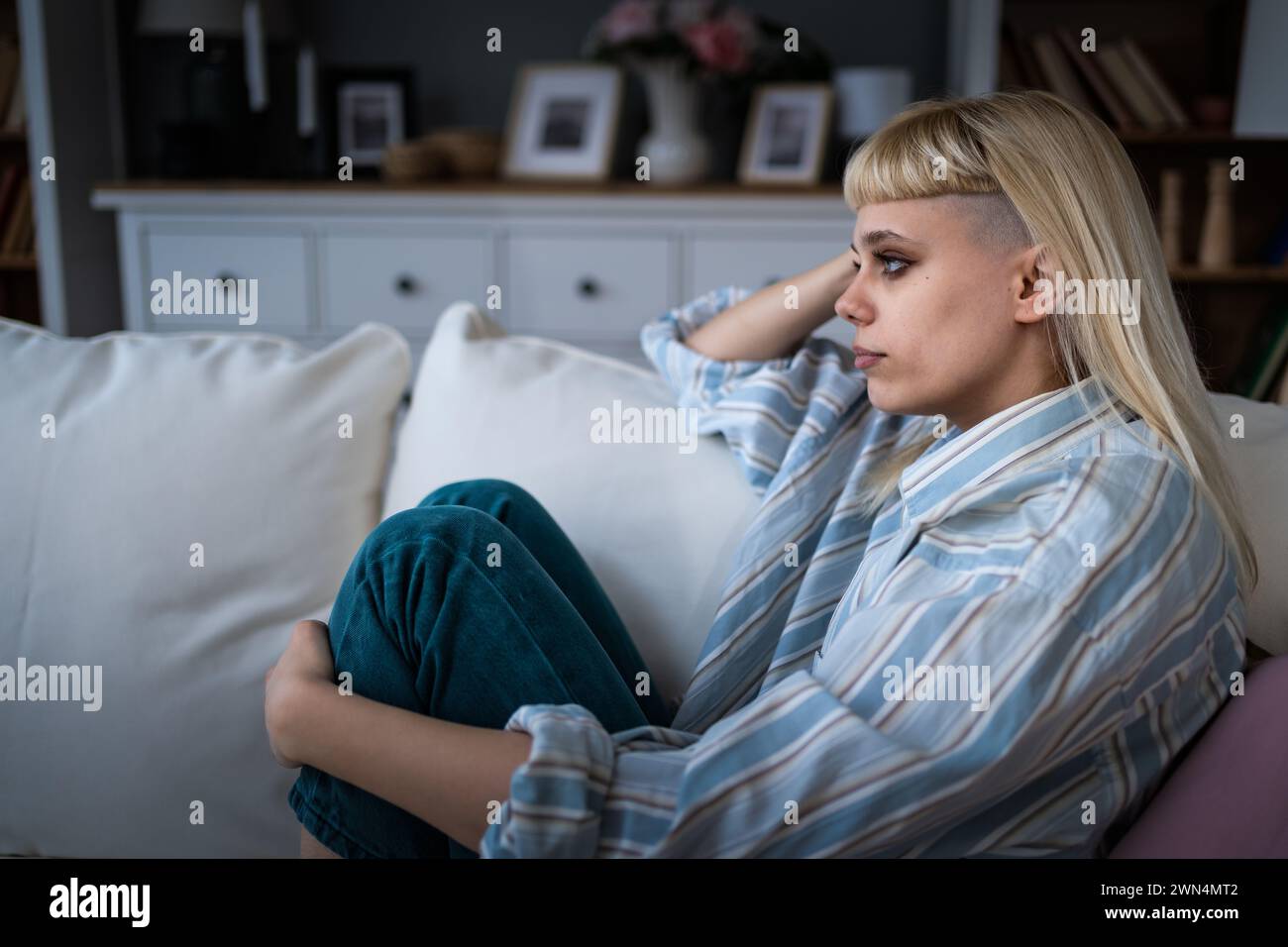 Caucasian sad woman sitting at the sofa with depression. Young student ...