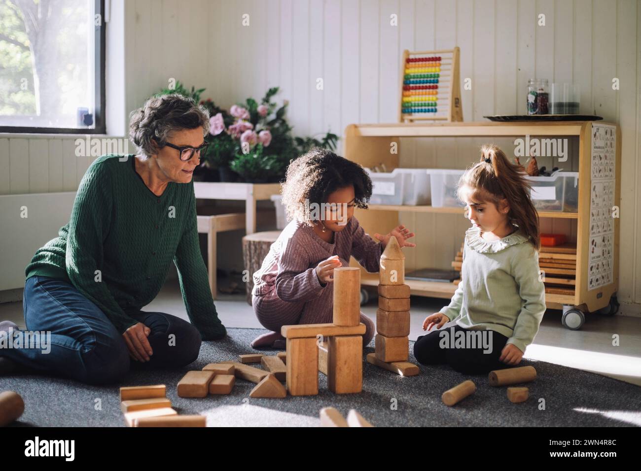 Children building blocks teacher hi-res stock photography and images ...